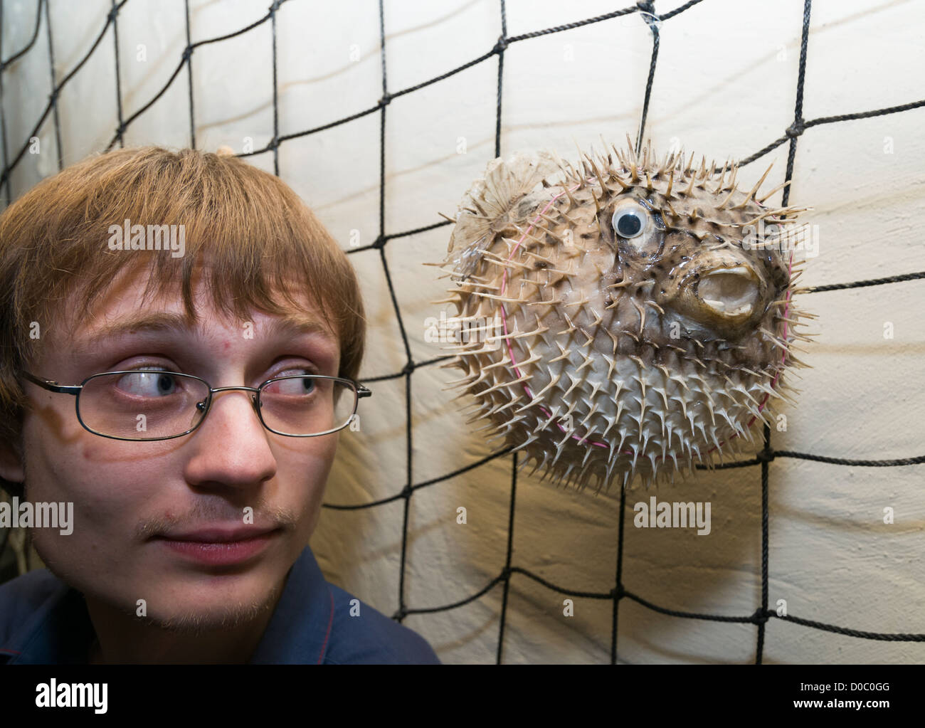 young man fish looking Stock Photo - Alamy