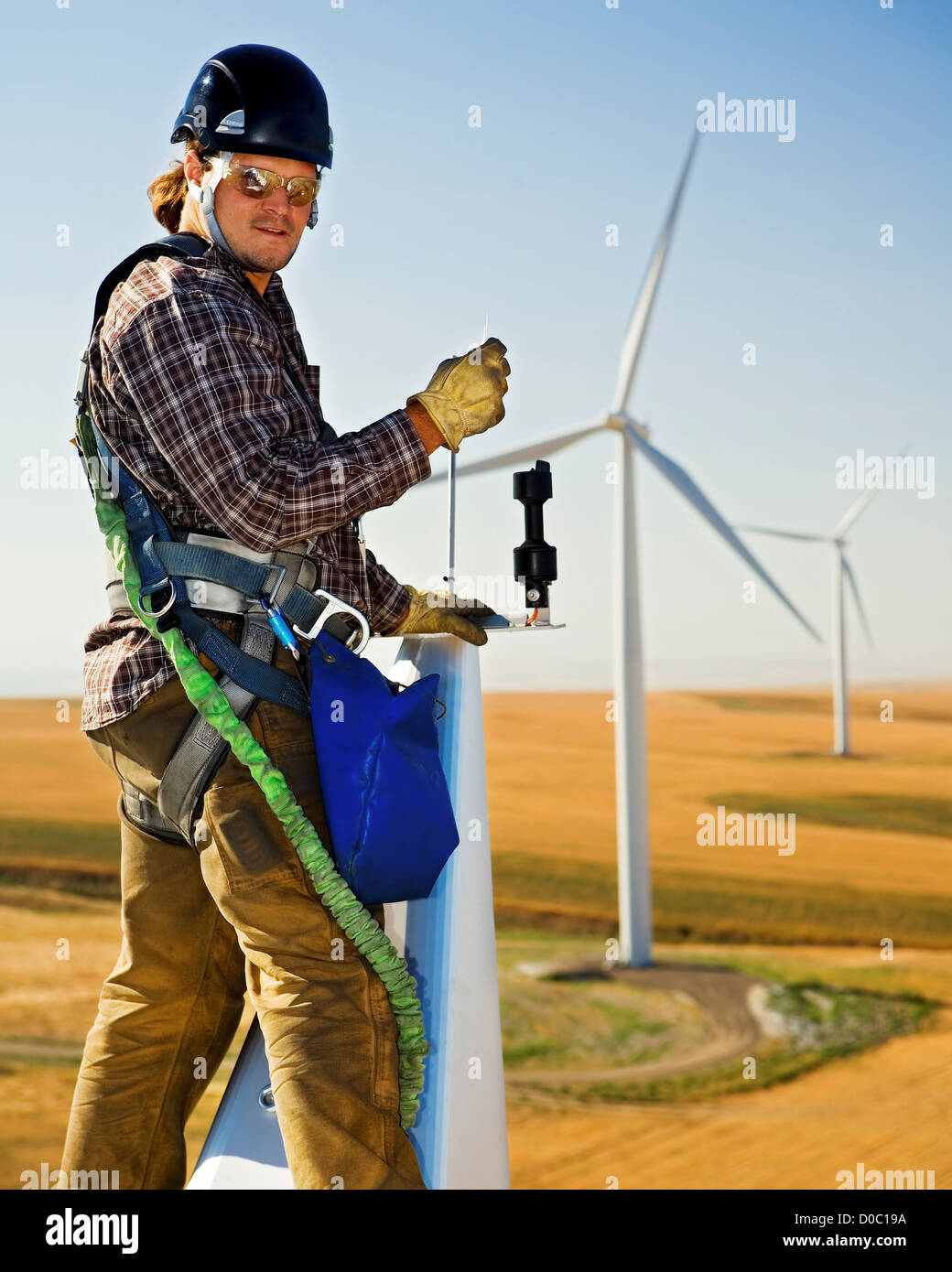 An Engineer Stands in the Open Nacelle of a Wind Tower and Checks a ...