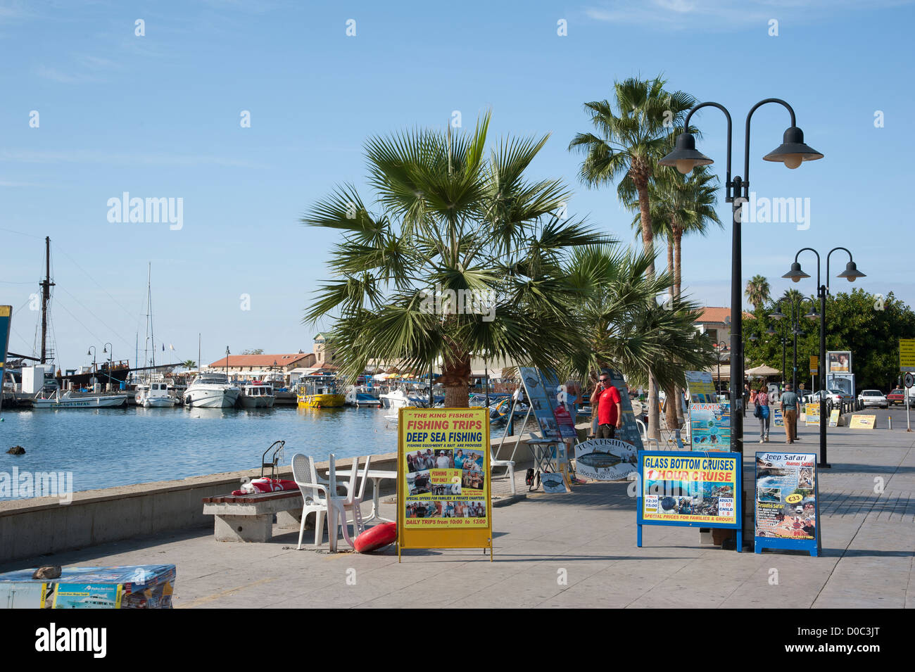 Harbour at Kato Pafos with advertising for boat trips on the seafront ...