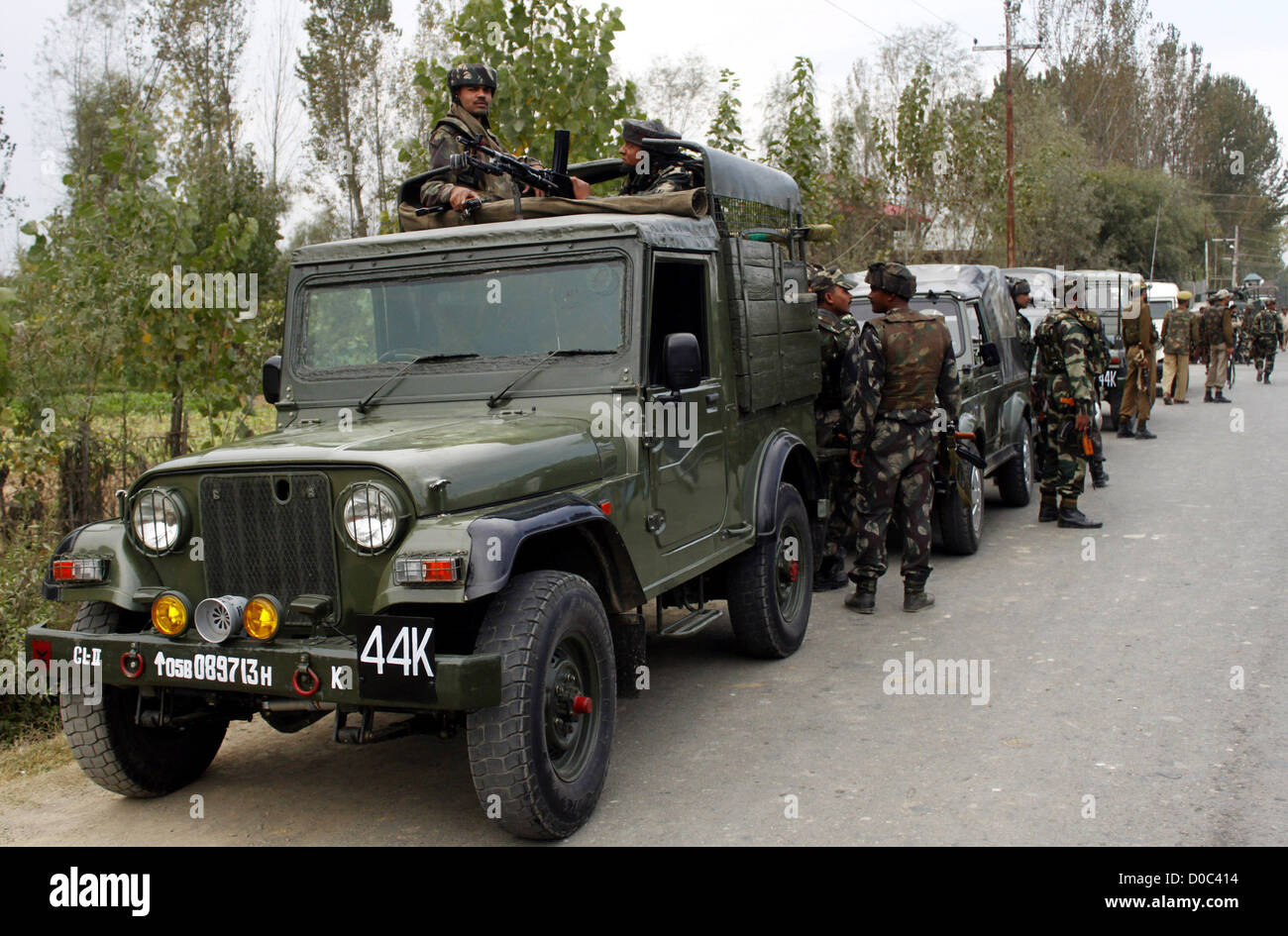 Indian Army soldiers take cover behind a wall as they try to storm a ...
