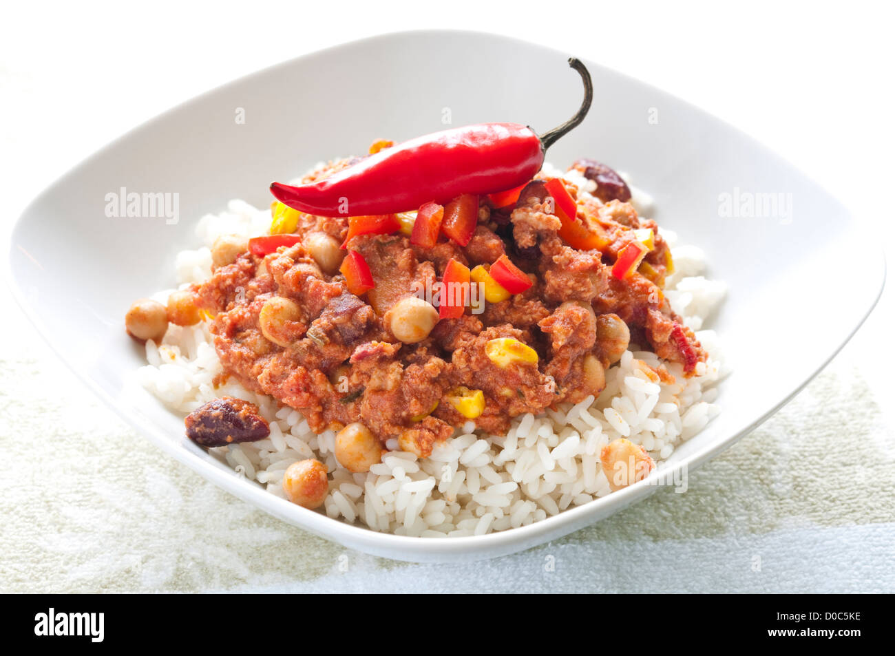 Rice with chili con carne and red chili peppers Stock Photo - Alamy
