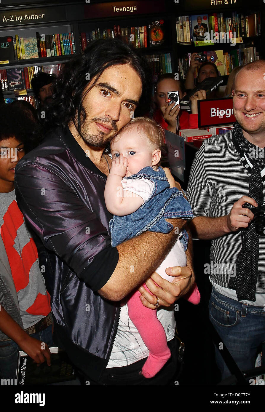 Russell Brand cuddles a baby as he visit's a Waterstone's Book Store to ...