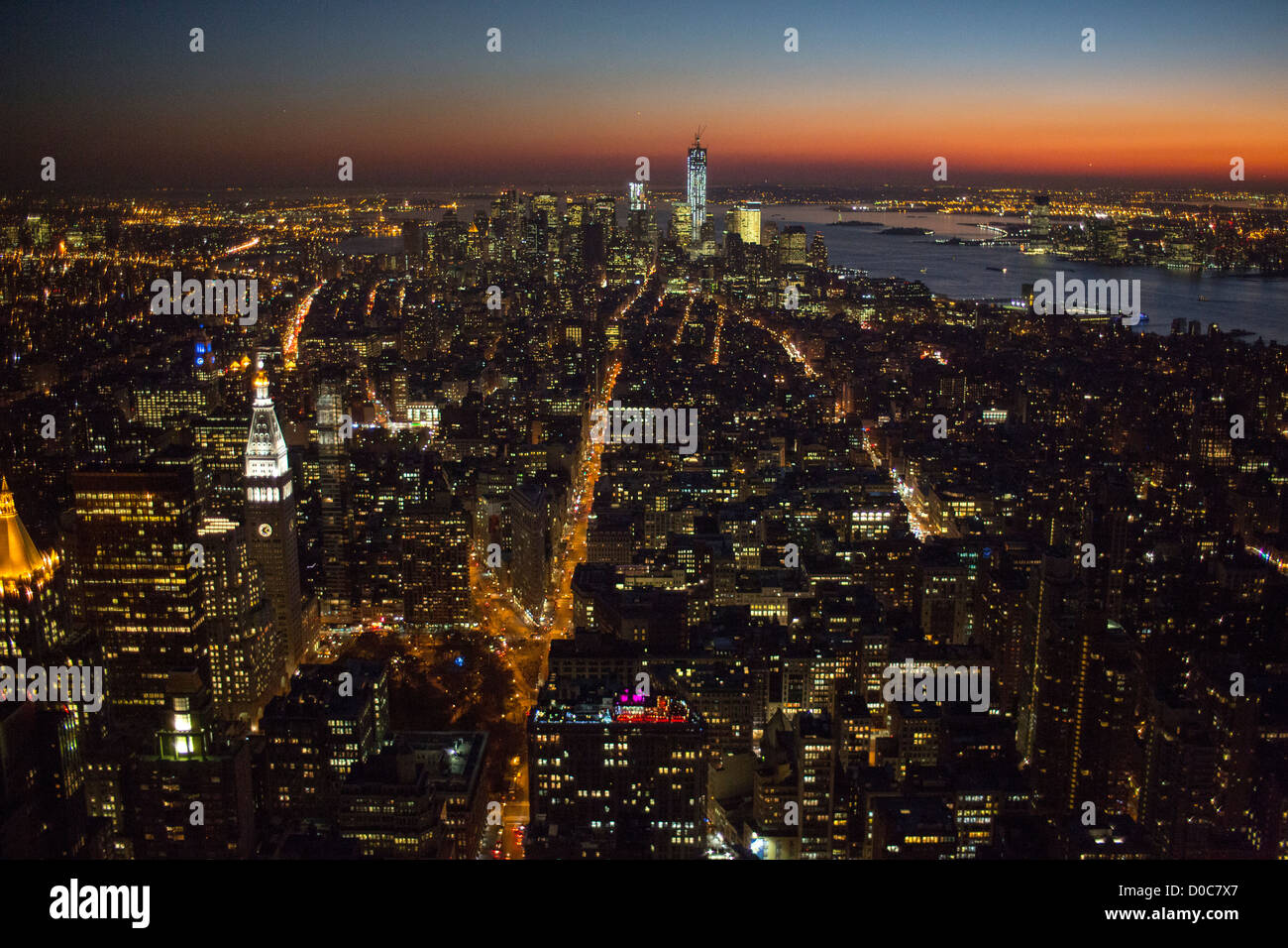 Tourists take in the view from the 86th floor observation deck of New ...