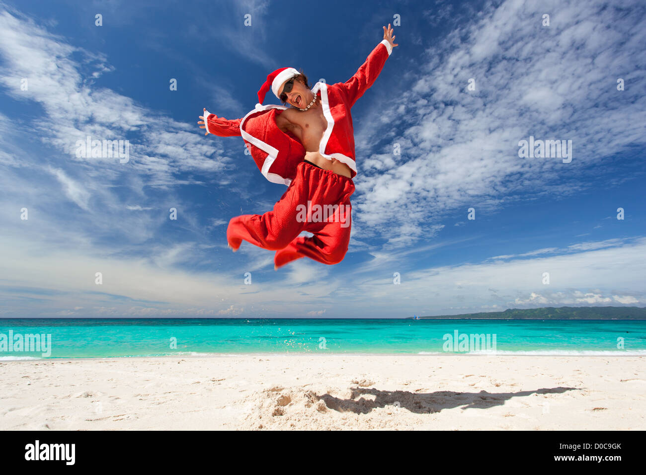 Santa Claus jumping on tropical beach Stock Photo - Alamy