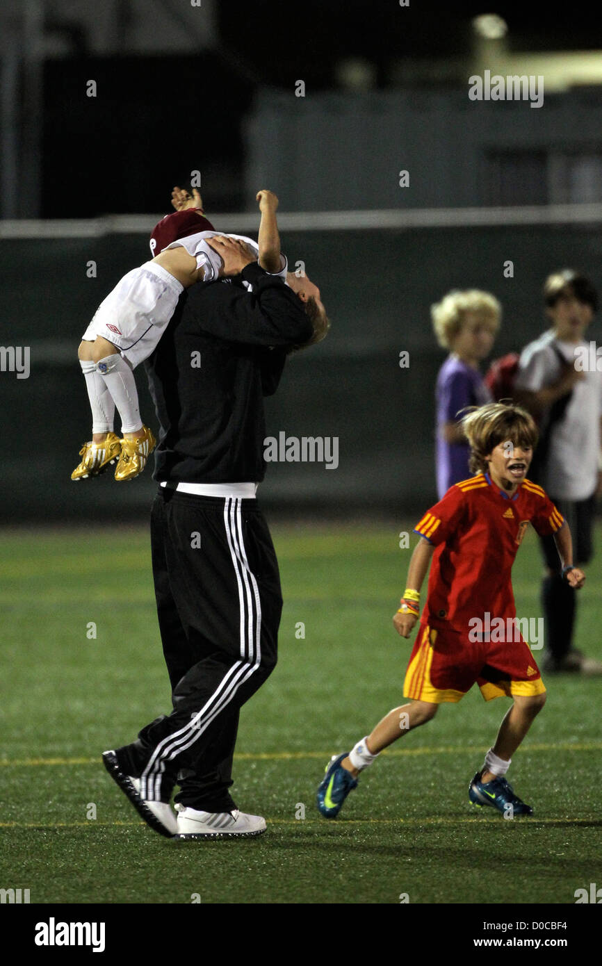 David Beckham plays ball with his two sons Romeo and Cruz during half ...