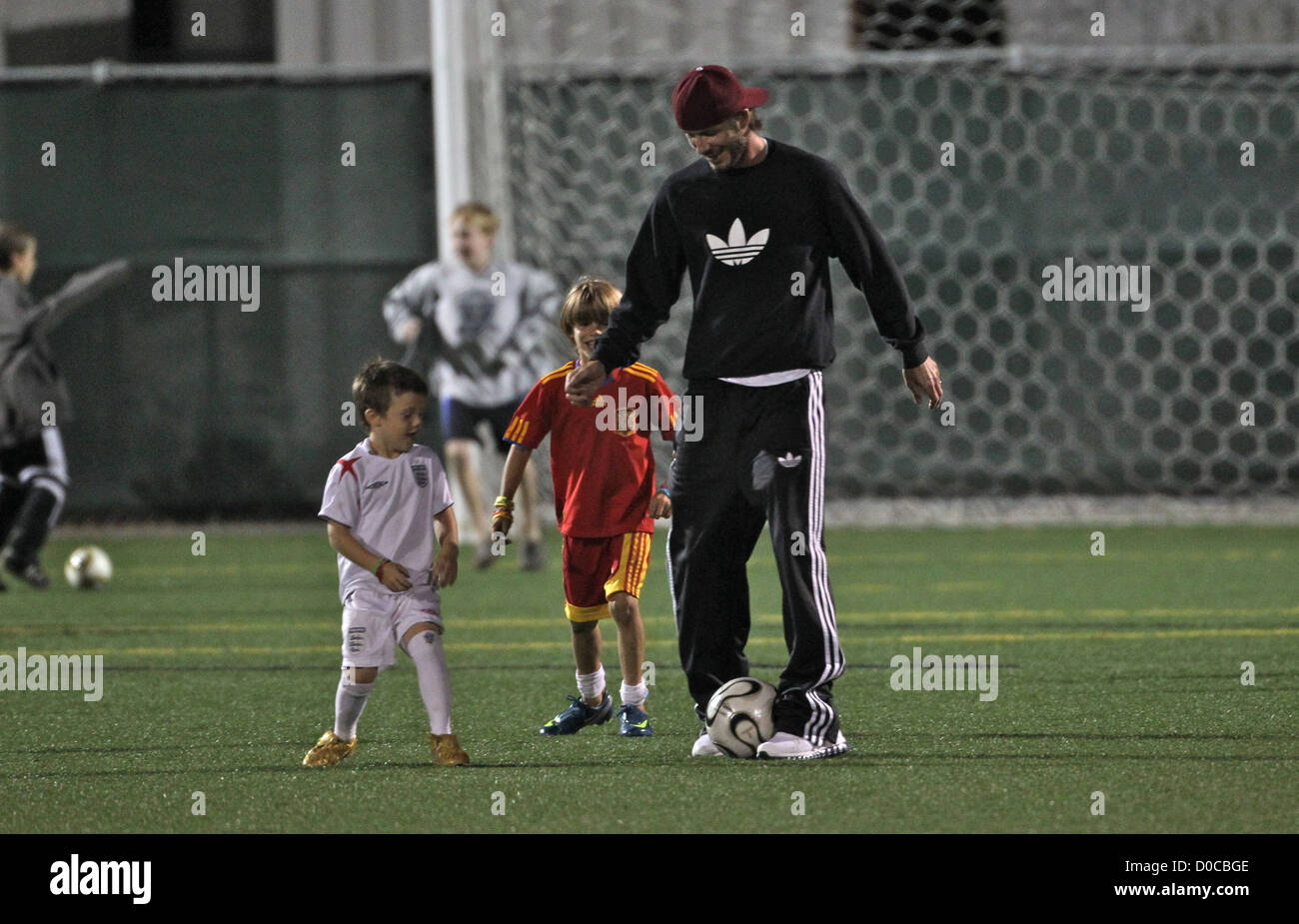 David Beckham plays ball with his two sons Romeo and Cruz during half ...