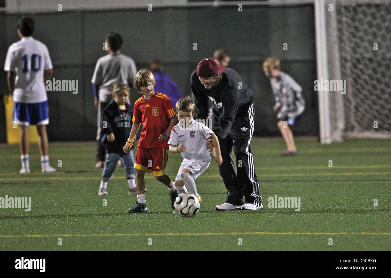 David Beckham plays ball with his two sons Romeo and Cruz during half ...