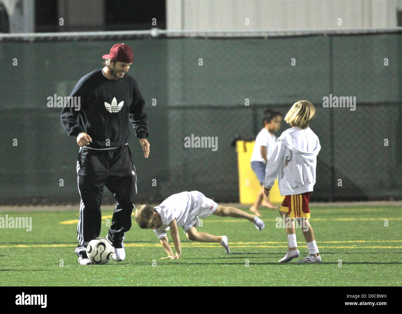 David Beckham plays ball with his two sons Romeo and Cruz during half ...