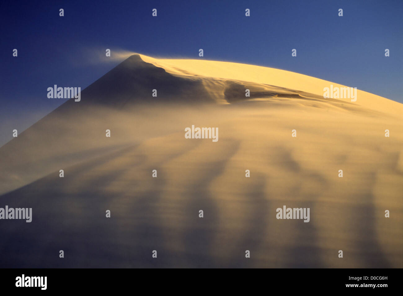 Wind Lifts a Banner of Sand Off the Crest of a Dune at Sunset Stock ...