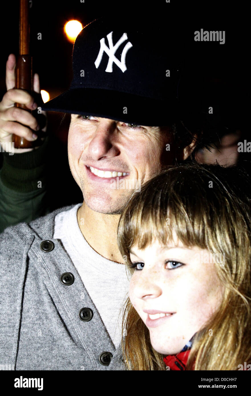 Tom Cruise poses with a fan after filming night scenes 'Mission ...