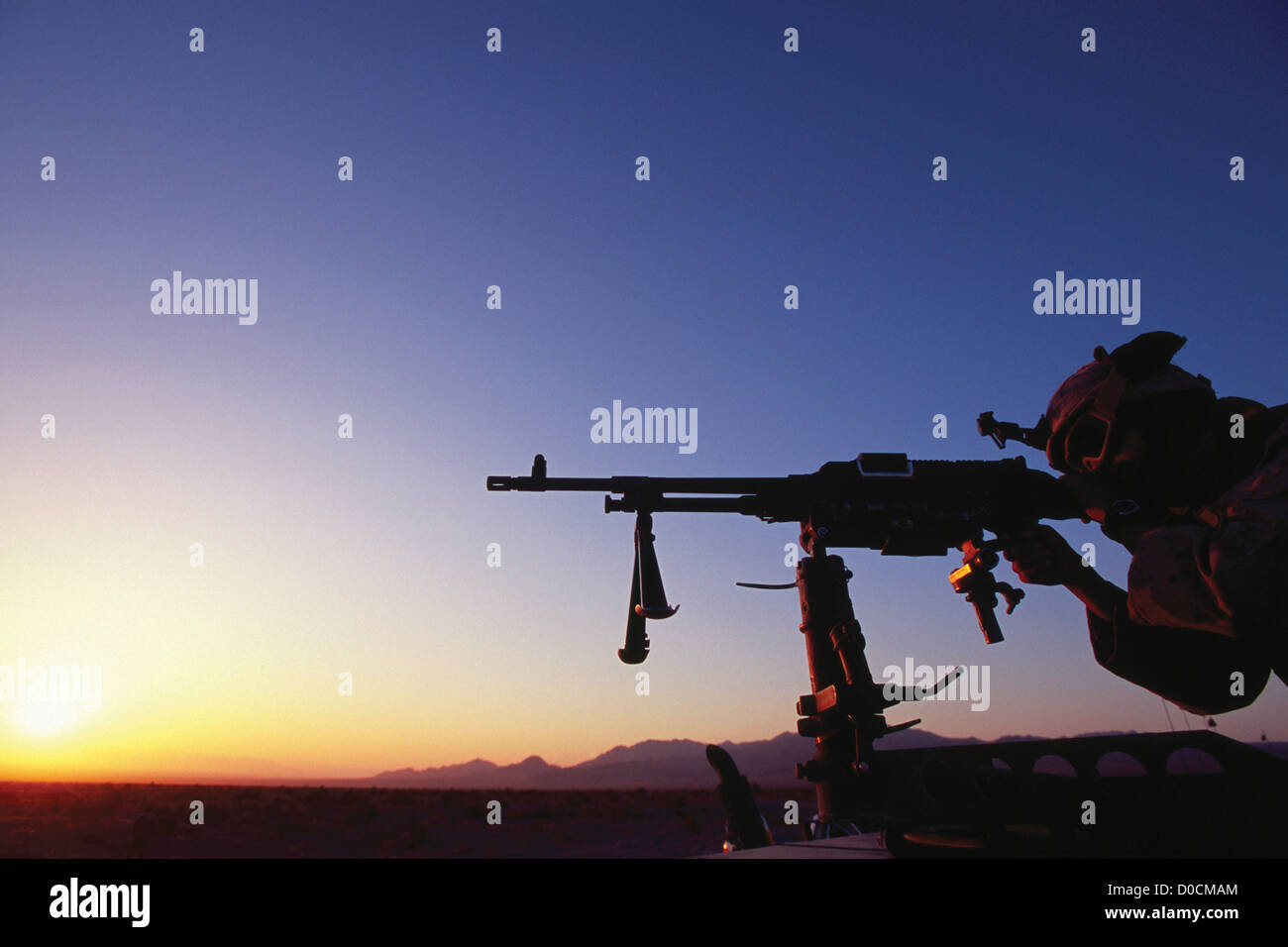 Silhouette of a US Marine Light Machine Gunner at Sunrise Stock Photo ...