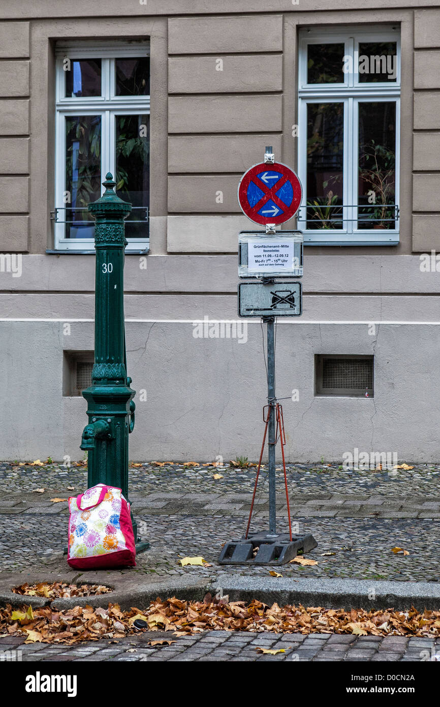 A Green fire-hydrant, a coloured shopping bag and temporary no-parking ...