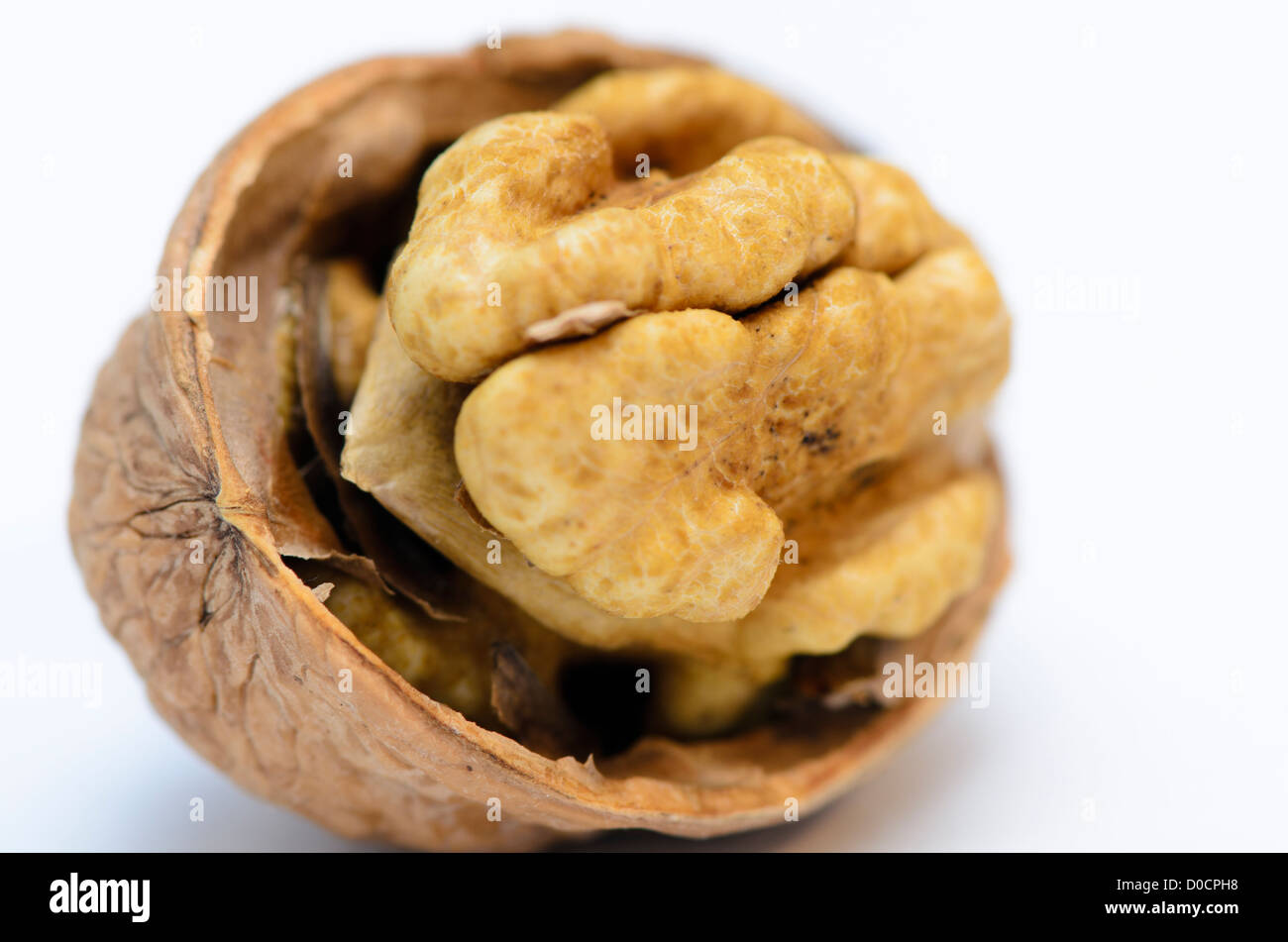 a cracked walnut isolated on white Stock Photo - Alamy