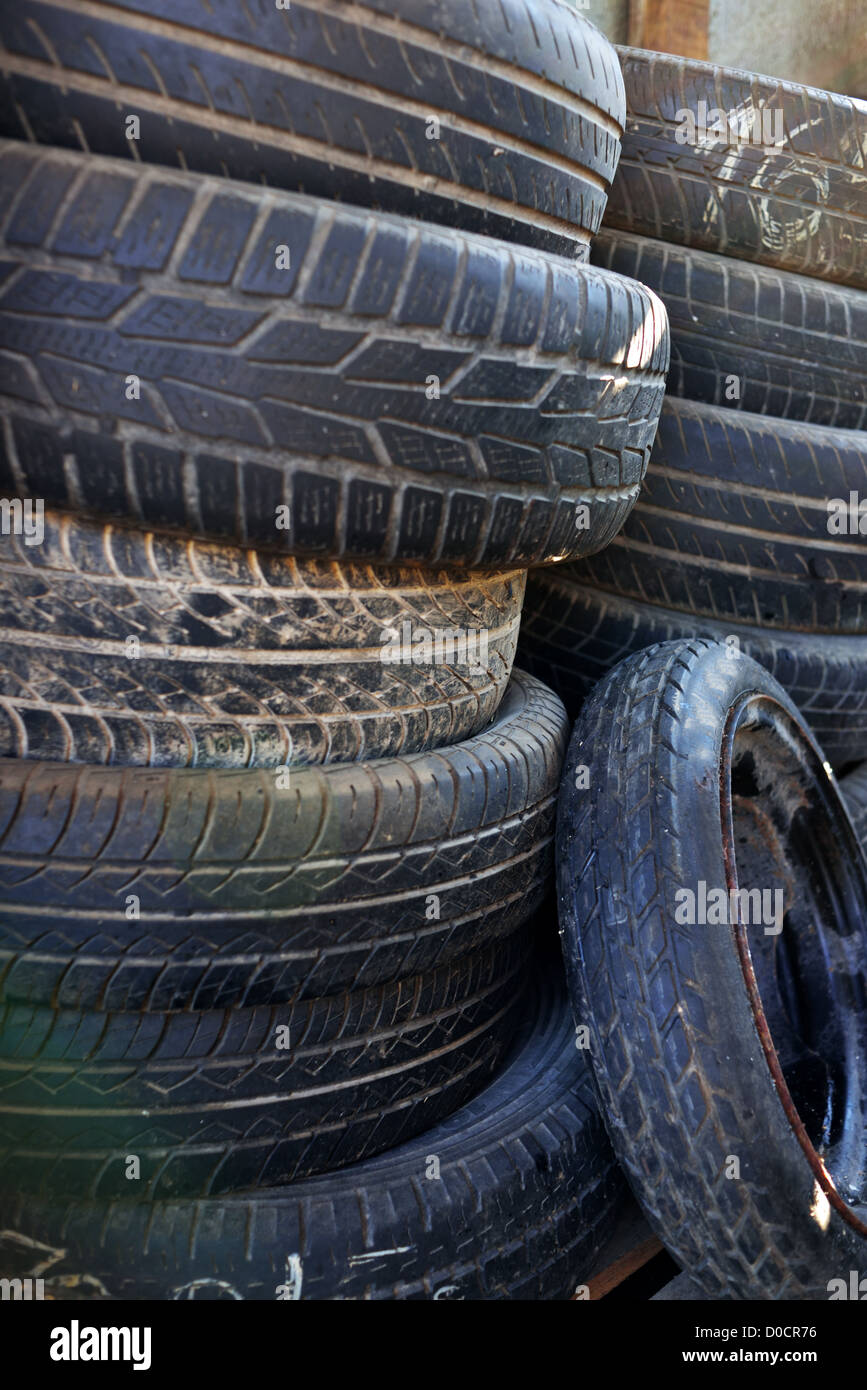 Stack of four wheel old black tyres for winter Stock Photo - Alamy