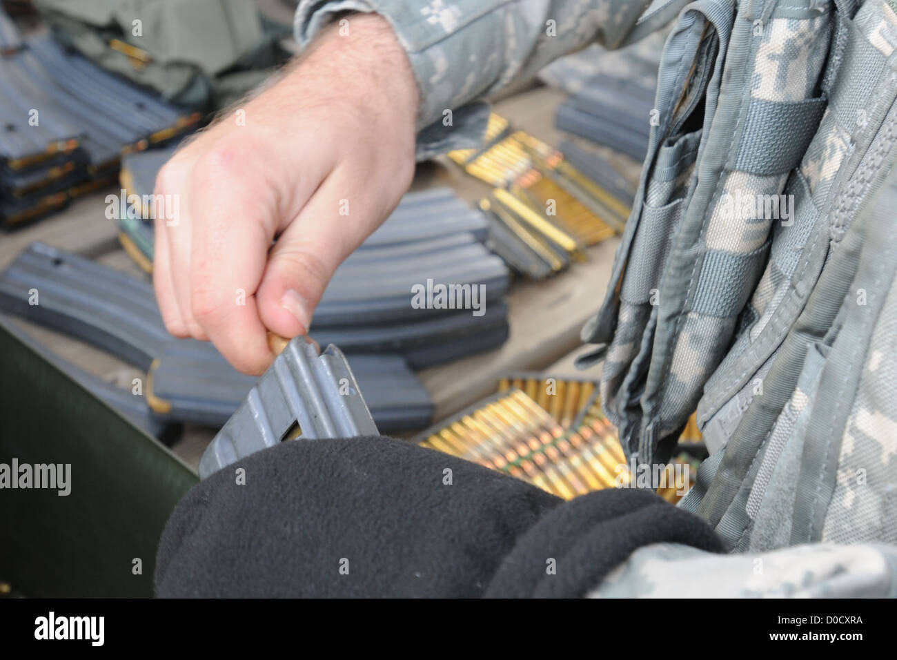 A Soldier loads rounds into his magazine during a Marksmanship ...