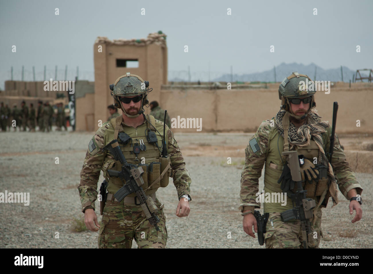 Coalition force members walk through an Afghan National Army compound ...