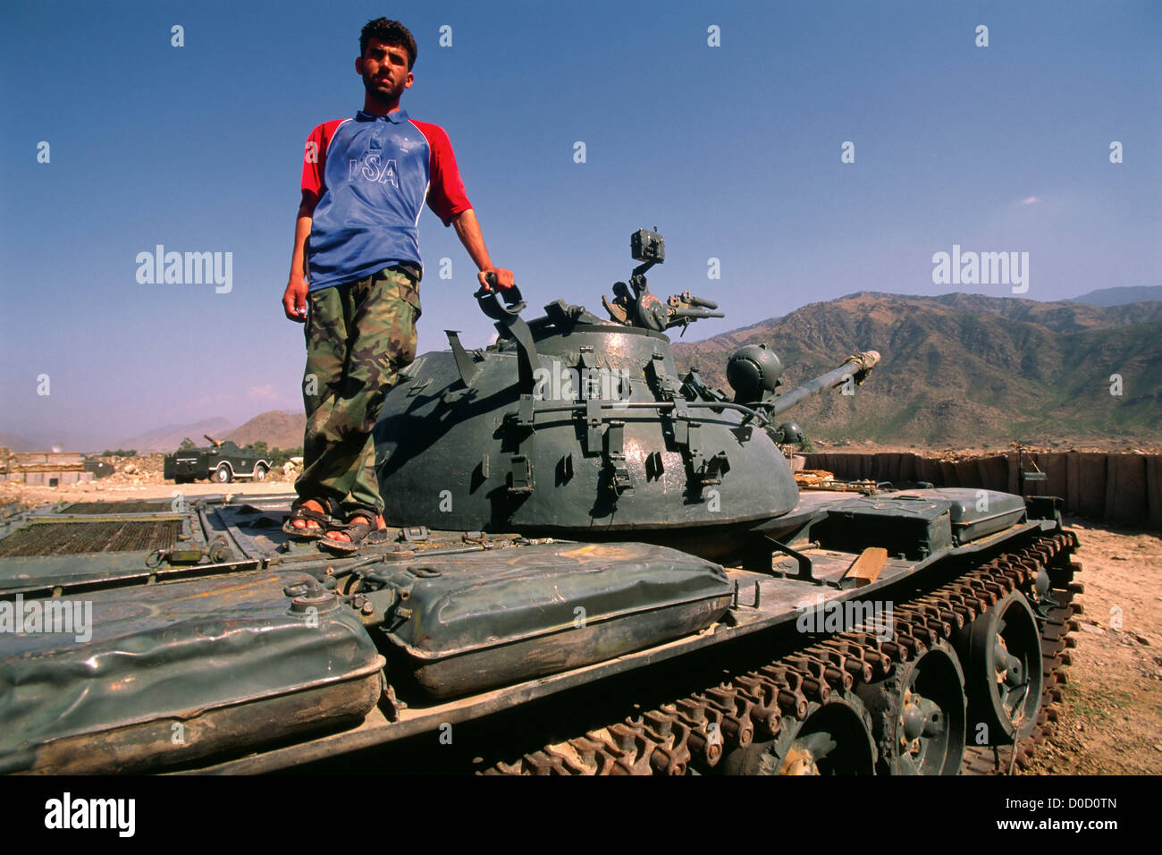 An Afghan Fighter, Wearing a USA Shirt, Shows Off a Captured Taliban ...