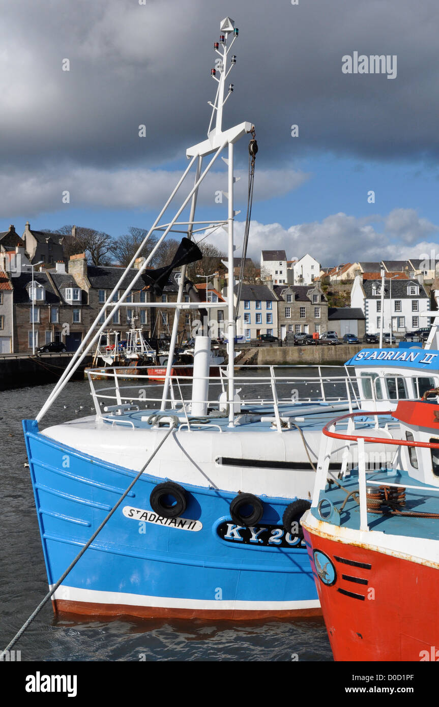 The bow and stern of fishing boats moored in the harbour, Pittenweem ...