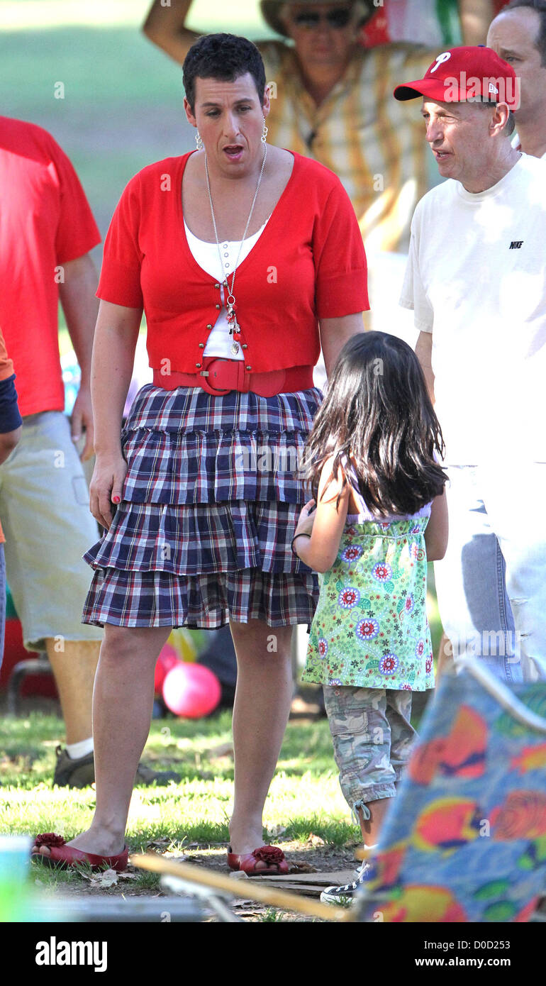 Adam Sandler dressed as a woman in a red cardigan and skirt, on the ...