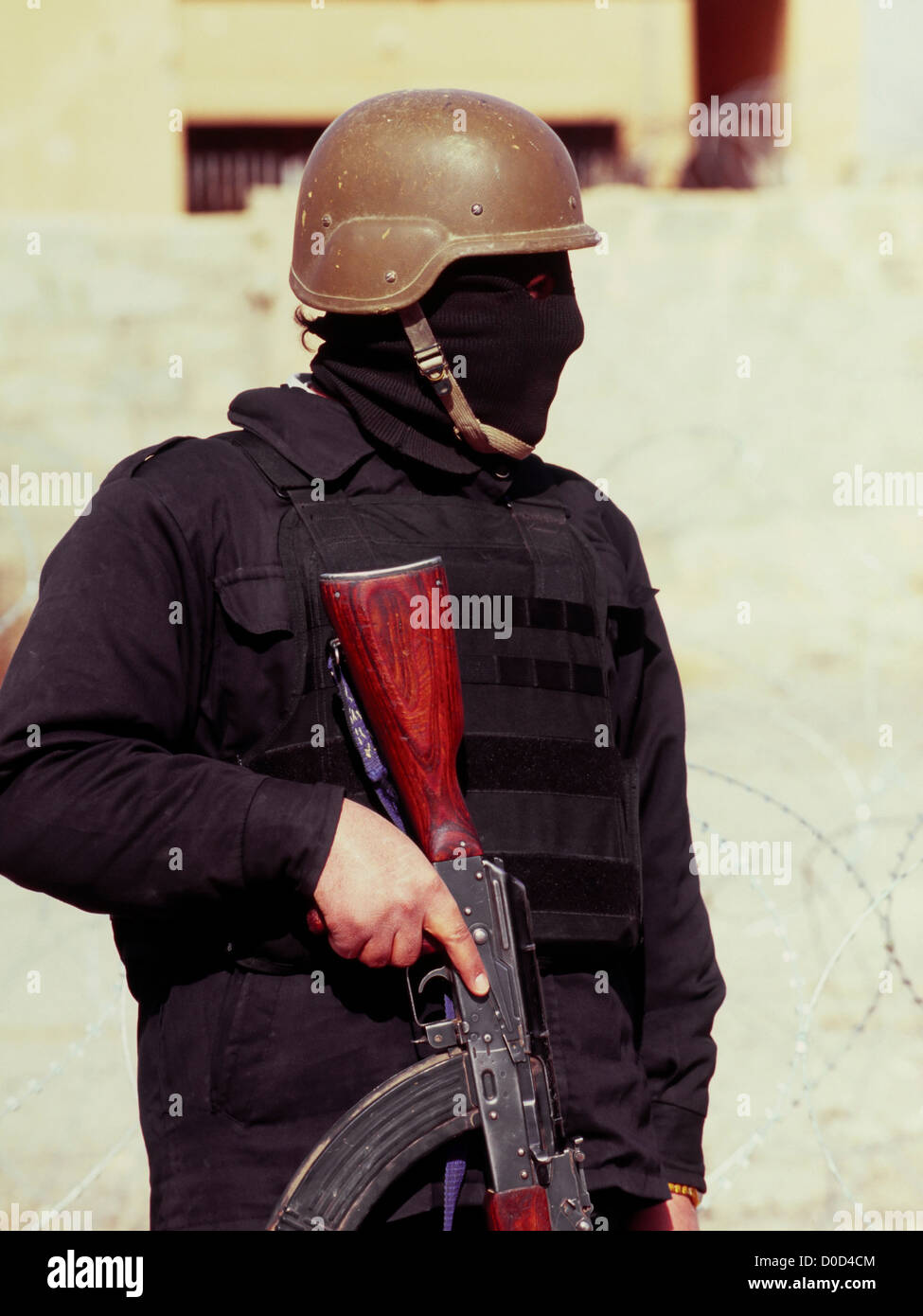 A Masked Member of the Iraqi National Police Holds His AK-47 in the ...