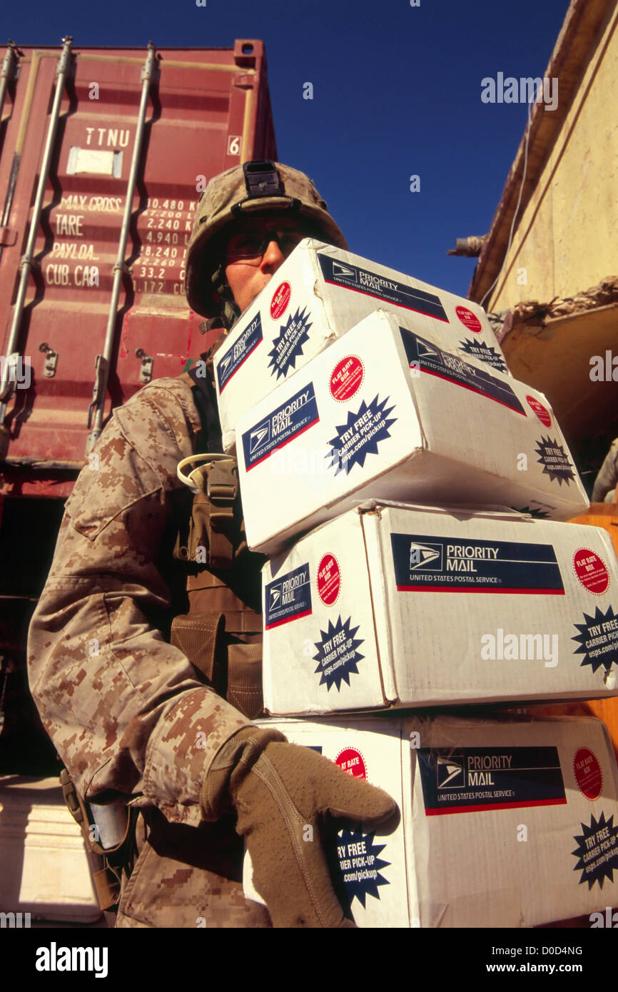 A US Marine Carries a Load of Parcels into the Headquarters of a Combat ...