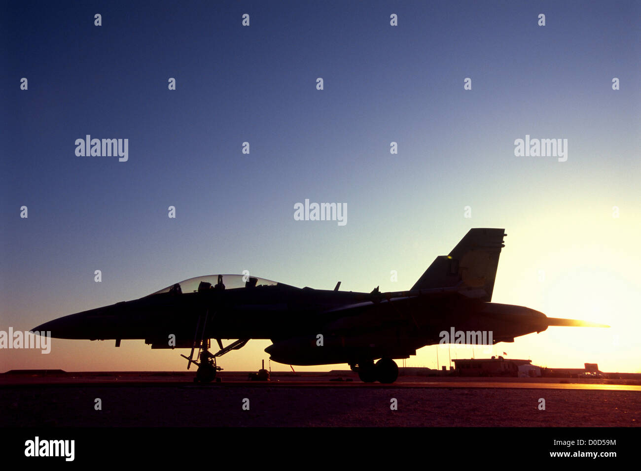 Silhouette of a US Marine F/A - 18D Hornet at Al Asad Air Base in the ...
