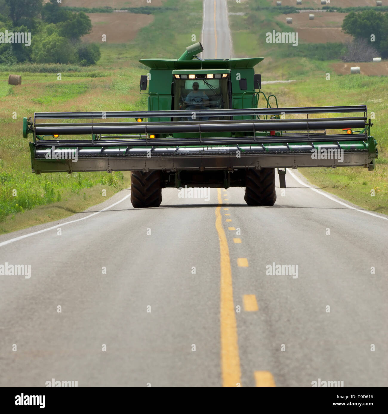 Wheat Combine on Rural Highway Stock Photo - Alamy