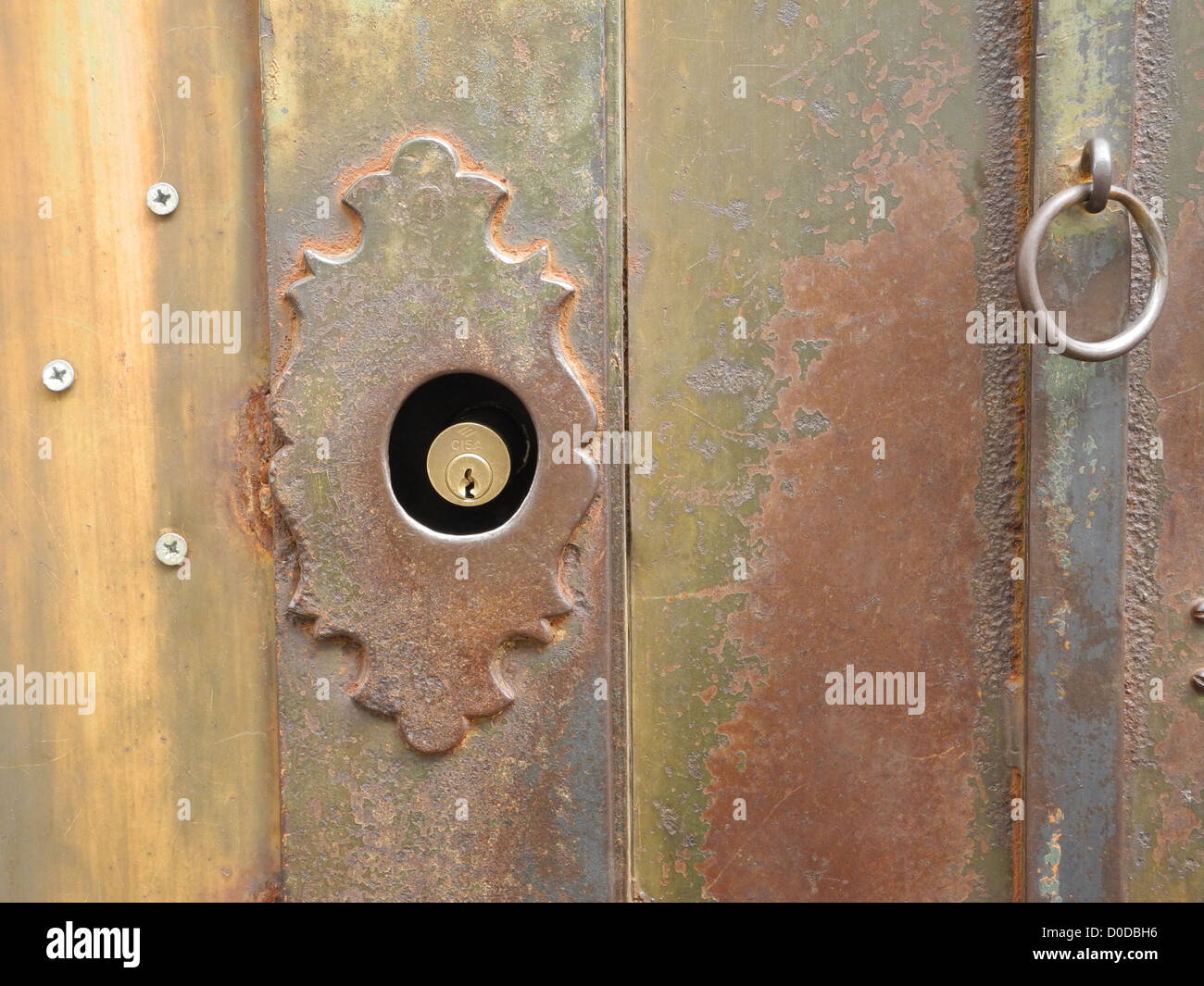 Modern Yale lock on an old weathered metal door in Florence Tuscany ...
