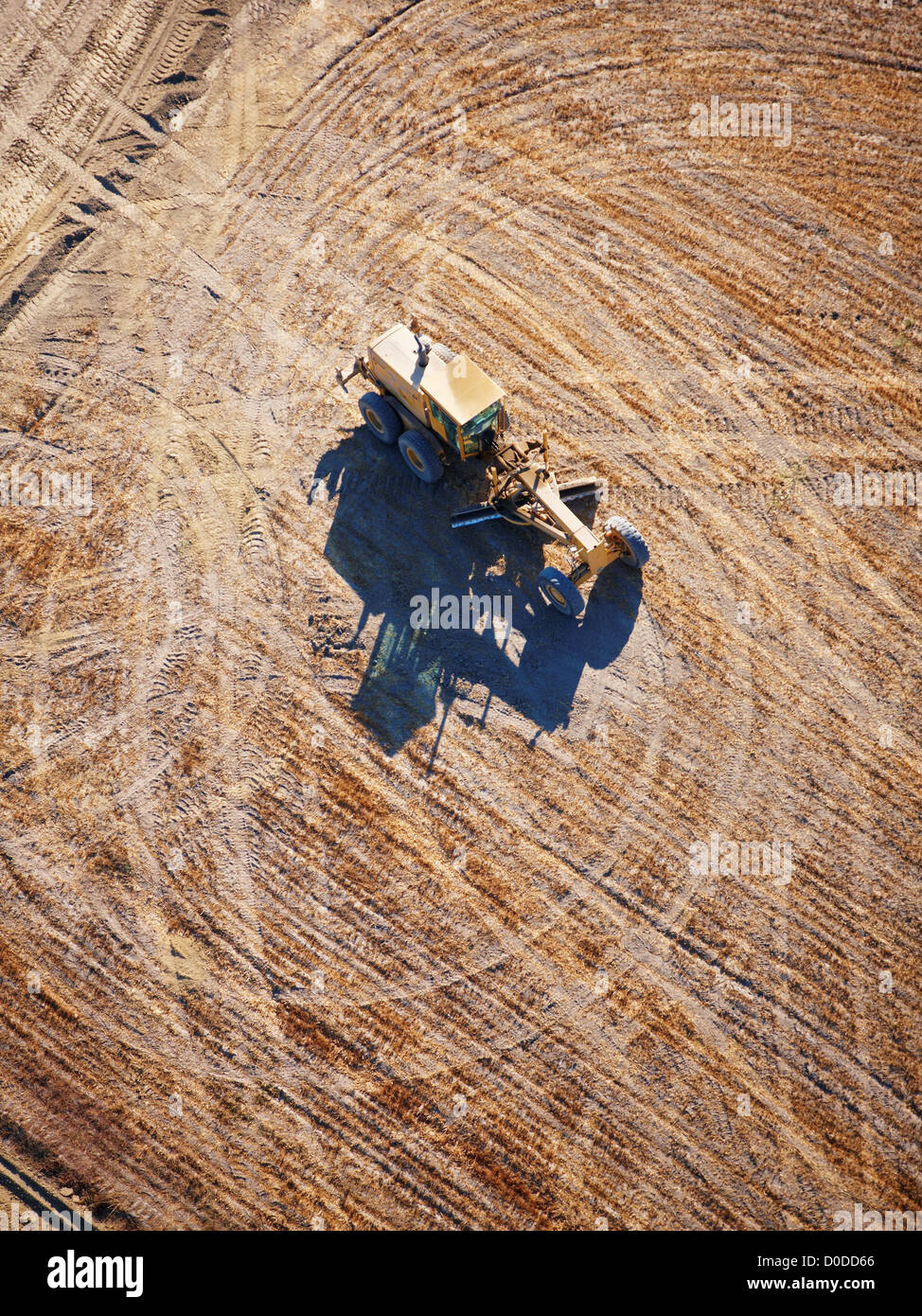 An aerial view of a large grader used to plane large swaths of earth ...