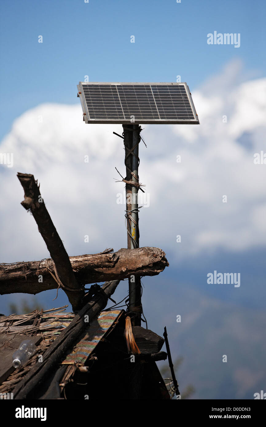 A small solar panel atop roof in Mure Village in eastern Nepal enables ...