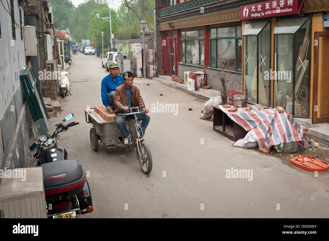 Chinese men on tricycle carry bricks to a building site, Hutongs ...