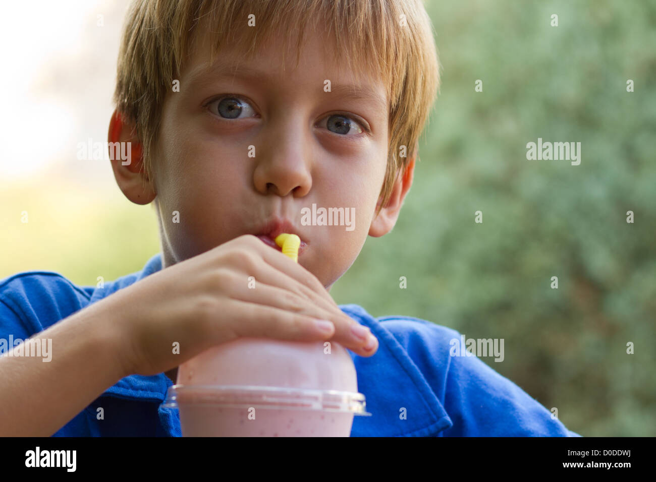 Little brother and sister drinking milkshakes in a cafe outdoors Stock ...