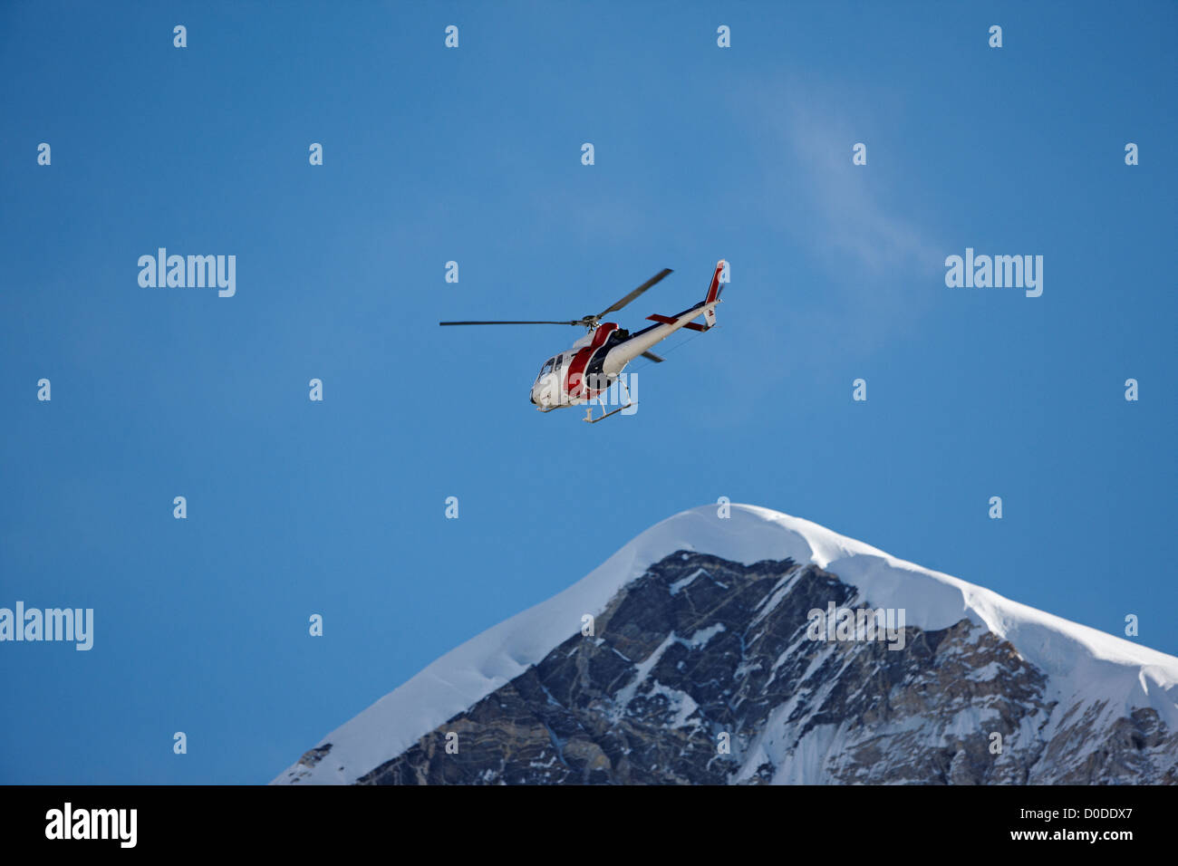 A rescue helicopter speeds toward Mount Everest Base Camp Stock Photo ...
