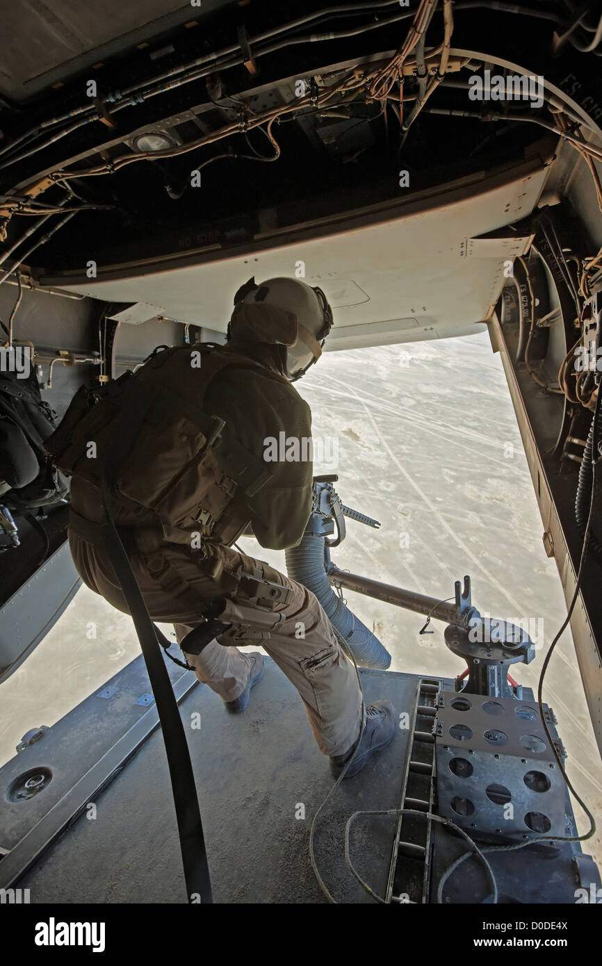 A U.S. Marine air crewman fires .50 caliber machine gun rear MV-22 ...