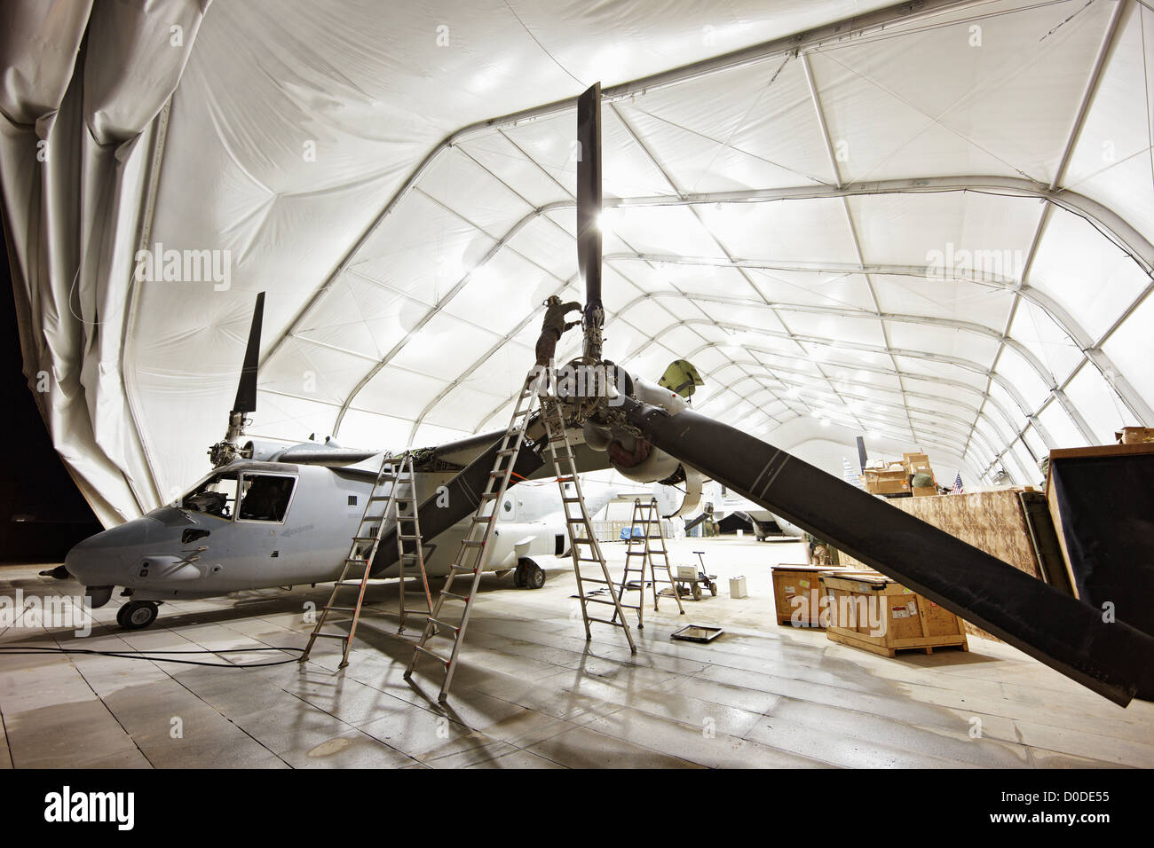 A U.S. Marine aircraft maintainer works on proprotor assembly in ...