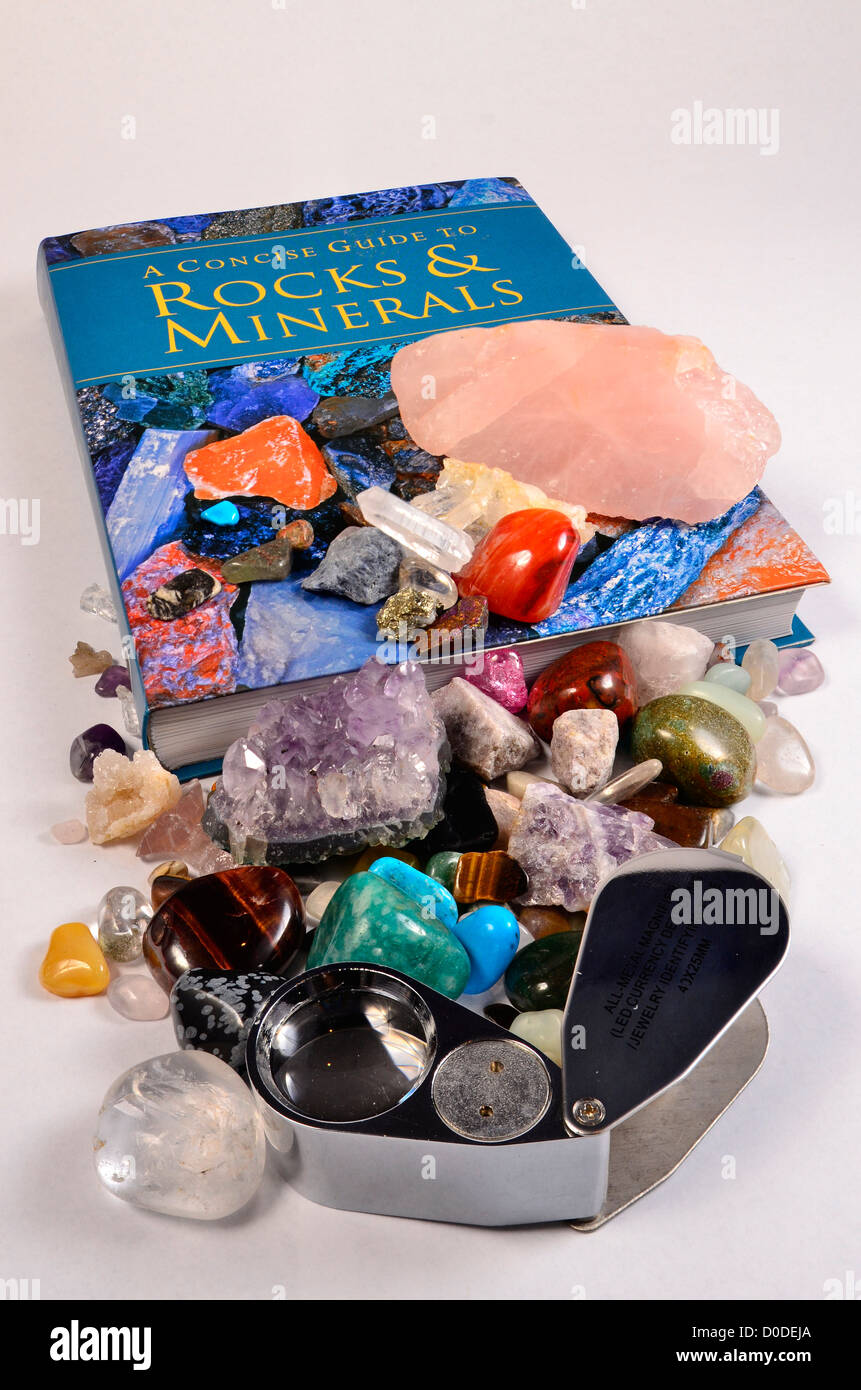 Rocks, Minerals & Magnifying glass with guide book Stock Photo - Alamy