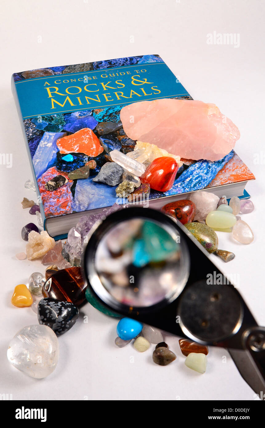 Rocks, Minerals & Magnifying glass with guide book Stock Photo - Alamy