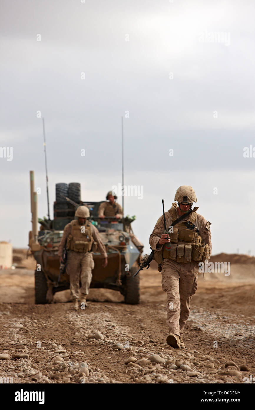U.S. Marines guide an LAV-25 Light Armored Vehicle at a combat outpost ...