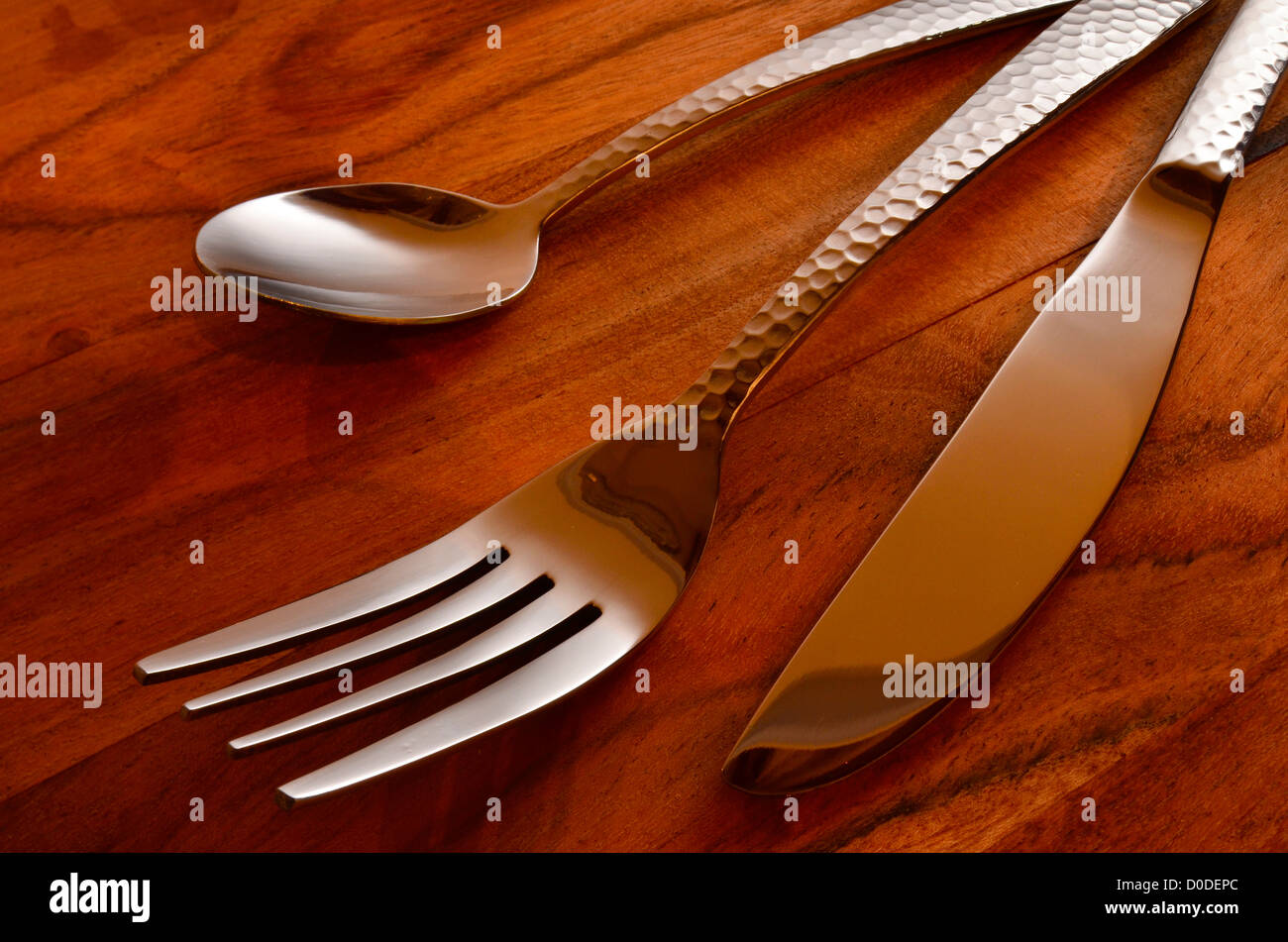 Cutlery on rustic wooden table Stock Photo - Alamy