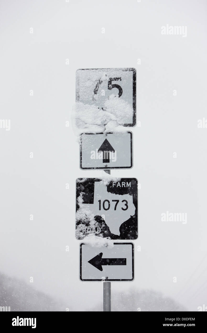 Snow covers road signs during a winter storm on Route 75, south of ...