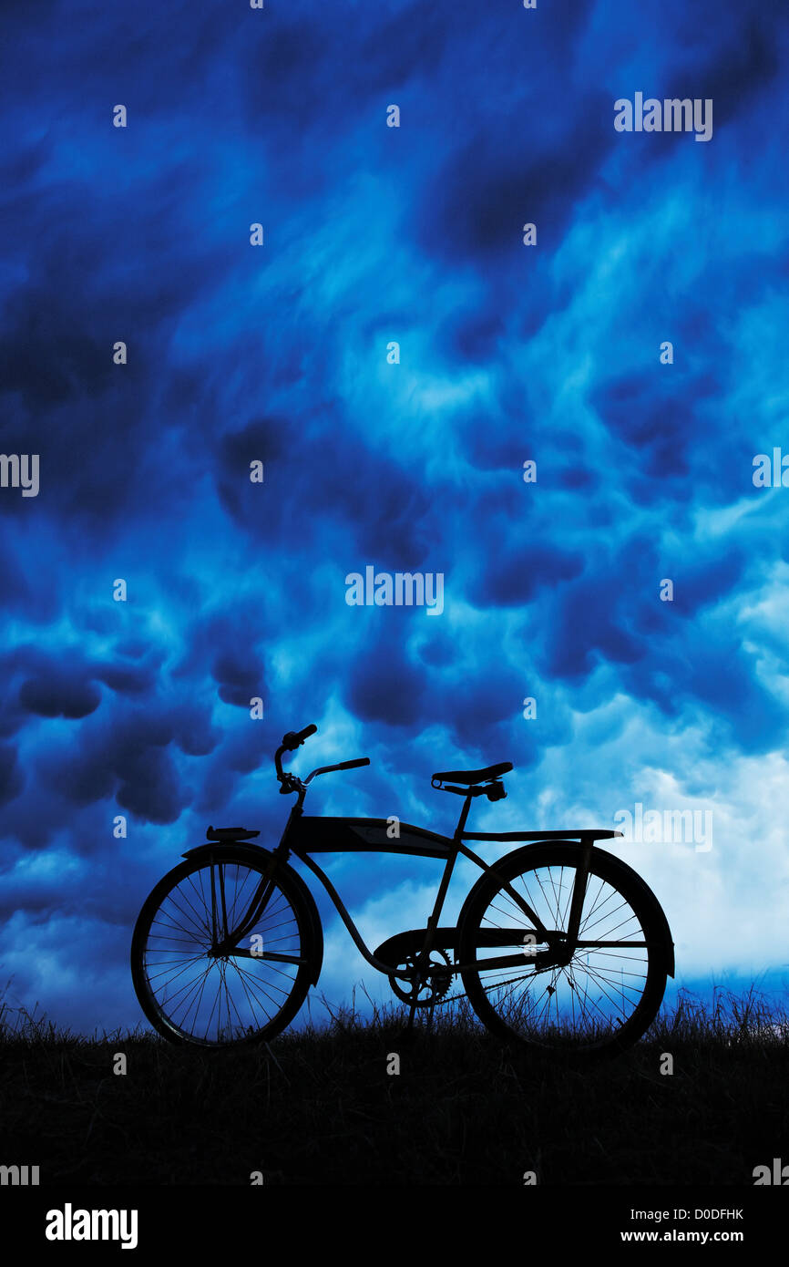 A cumulonimbus (thunderhead) mammatus cloud forms partially silhouettes ...