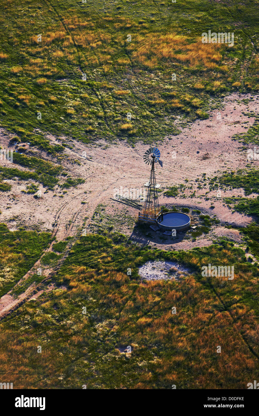 An aerial view of a water-pumping windmill and a cistern for cattle ...