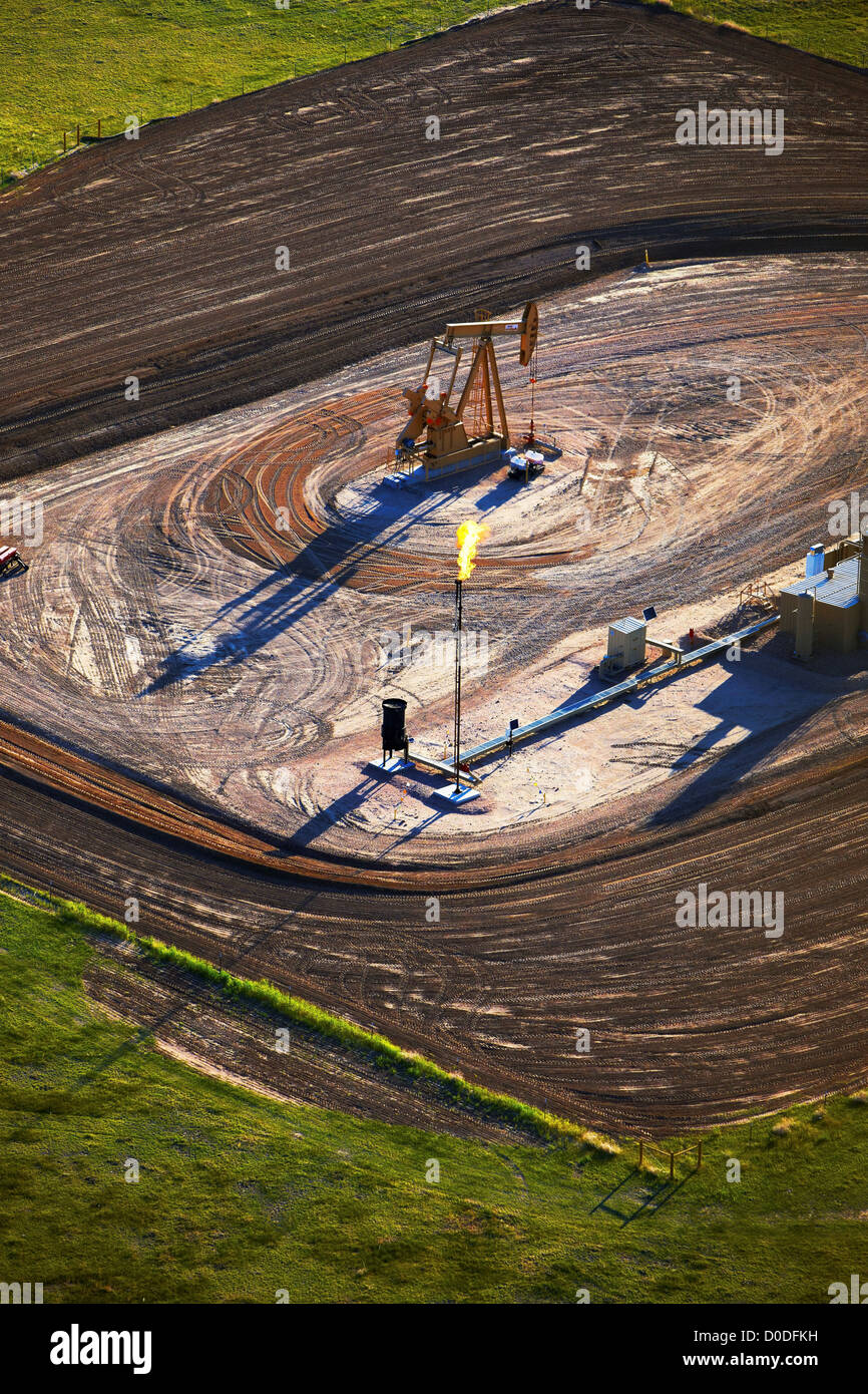An aerial view of an oil well pump jack and a flare stack, which burns ...