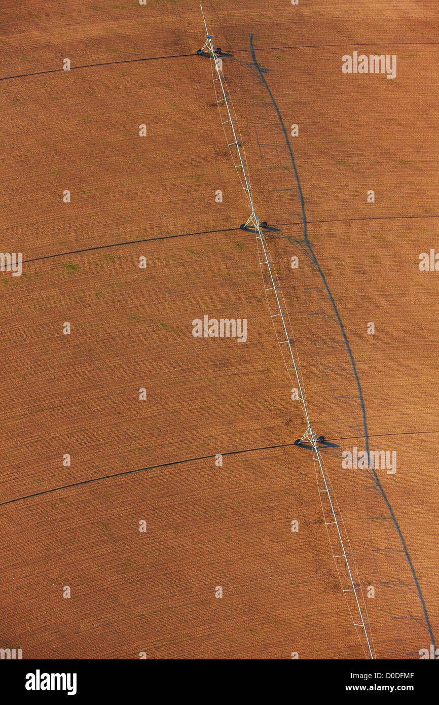An aerial view of a center pivot irrigation system on bare farm land ...