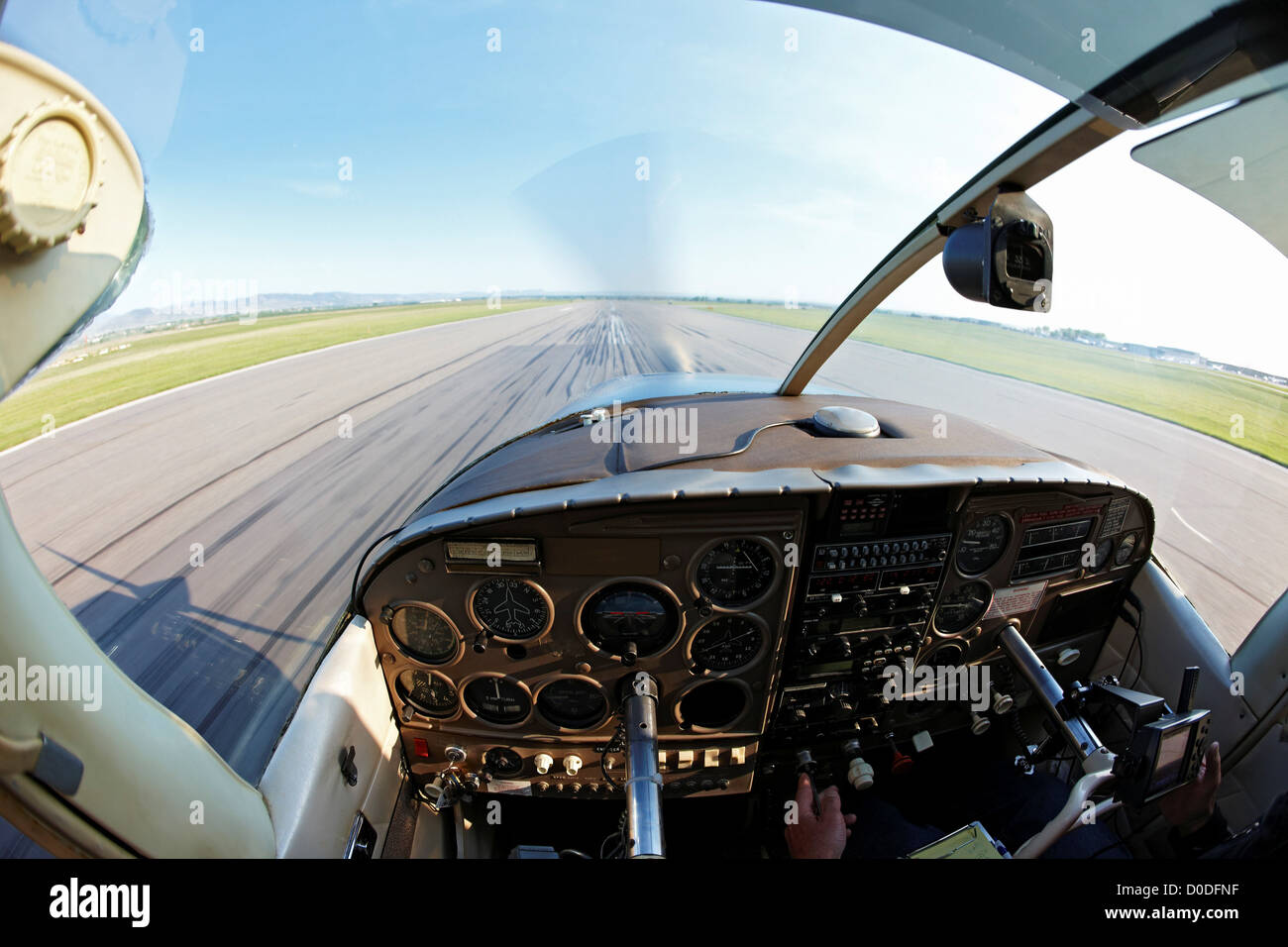 A forward looking view from a cockpit of the airport runway as a small aircraft lands Stock ...