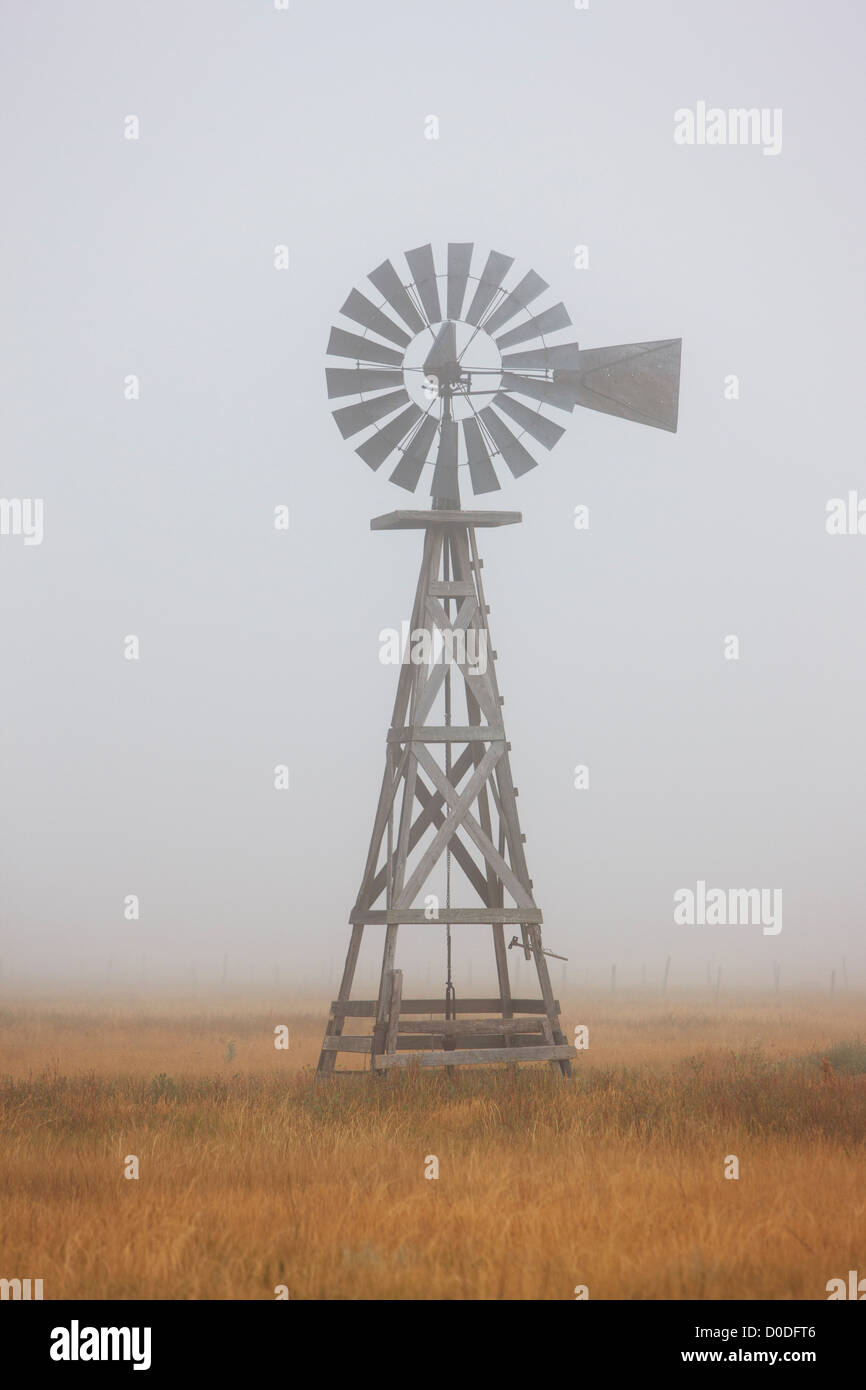A windmill for water pumping partially shrouded by a low cloud, eastern ...