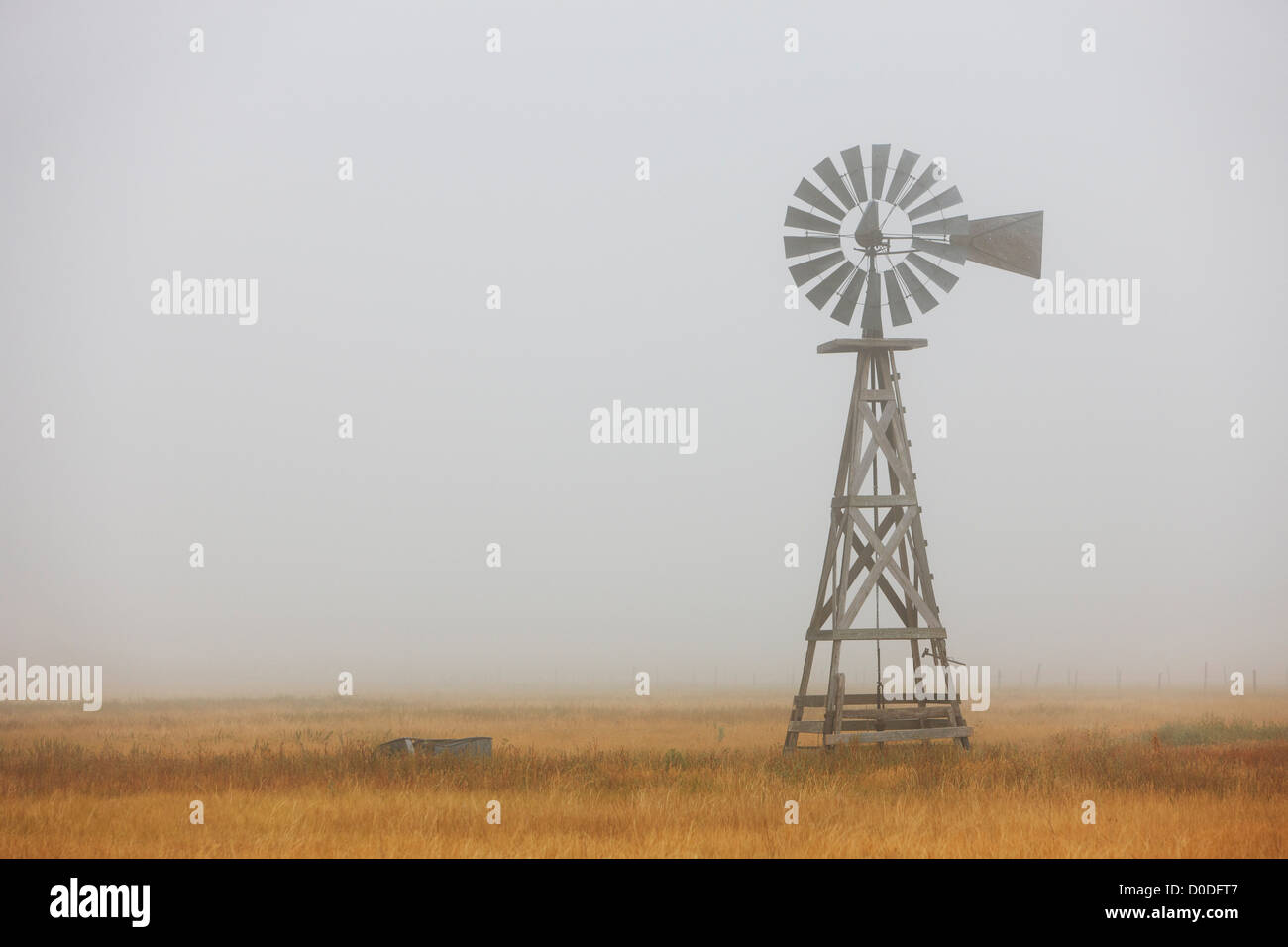 A windmill for water pumping partially shrouded by a low cloud, eastern ...