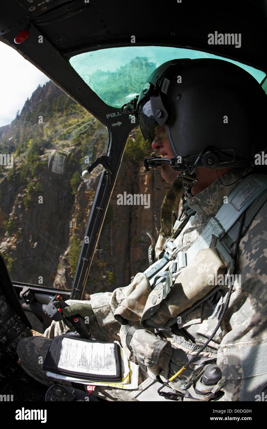 Cockpit view of a pilot of a Bell OH-58 Kiowa while flying in a deep ...