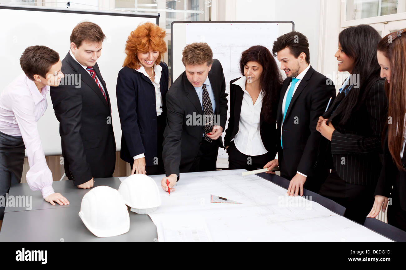 business team looking architecture project in office Stock Photo - Alamy