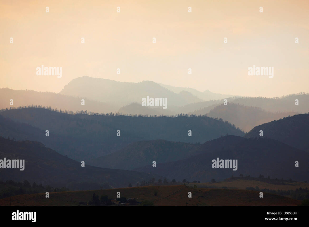 Ridges and mountains obscured by smoke from raging wildfire, northern ...